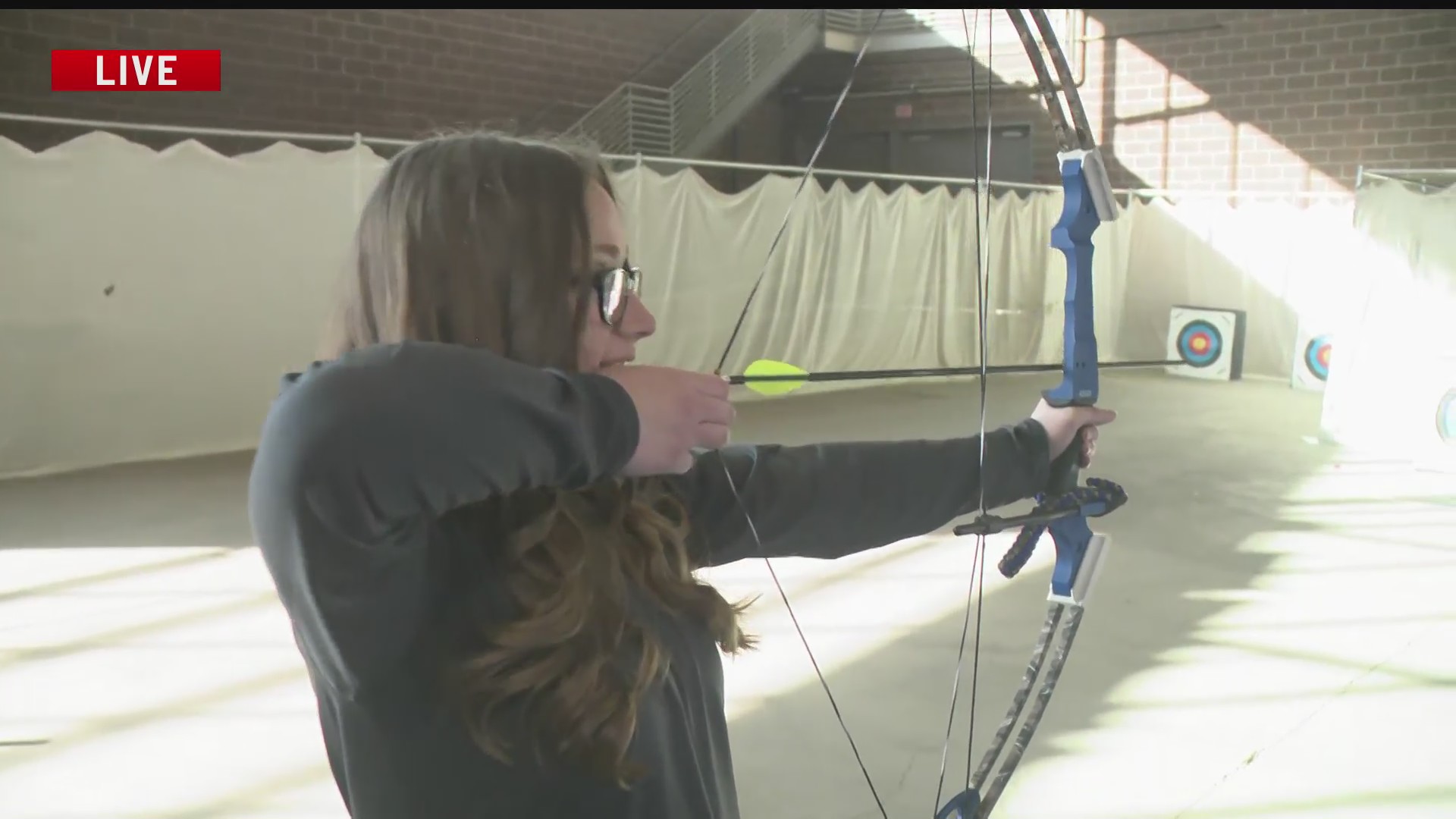 Learning how to shoot an arrow at the Iowa State Archery Tournament ...