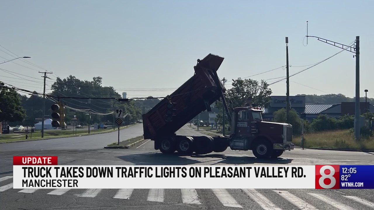 Bucket truck stuck on traffic light wires closes road in Manchester ...