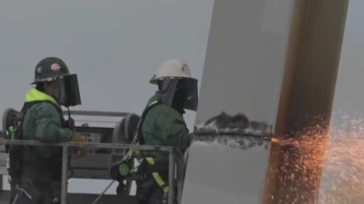 Crews carefully start removing first piece of twisted steel from ...