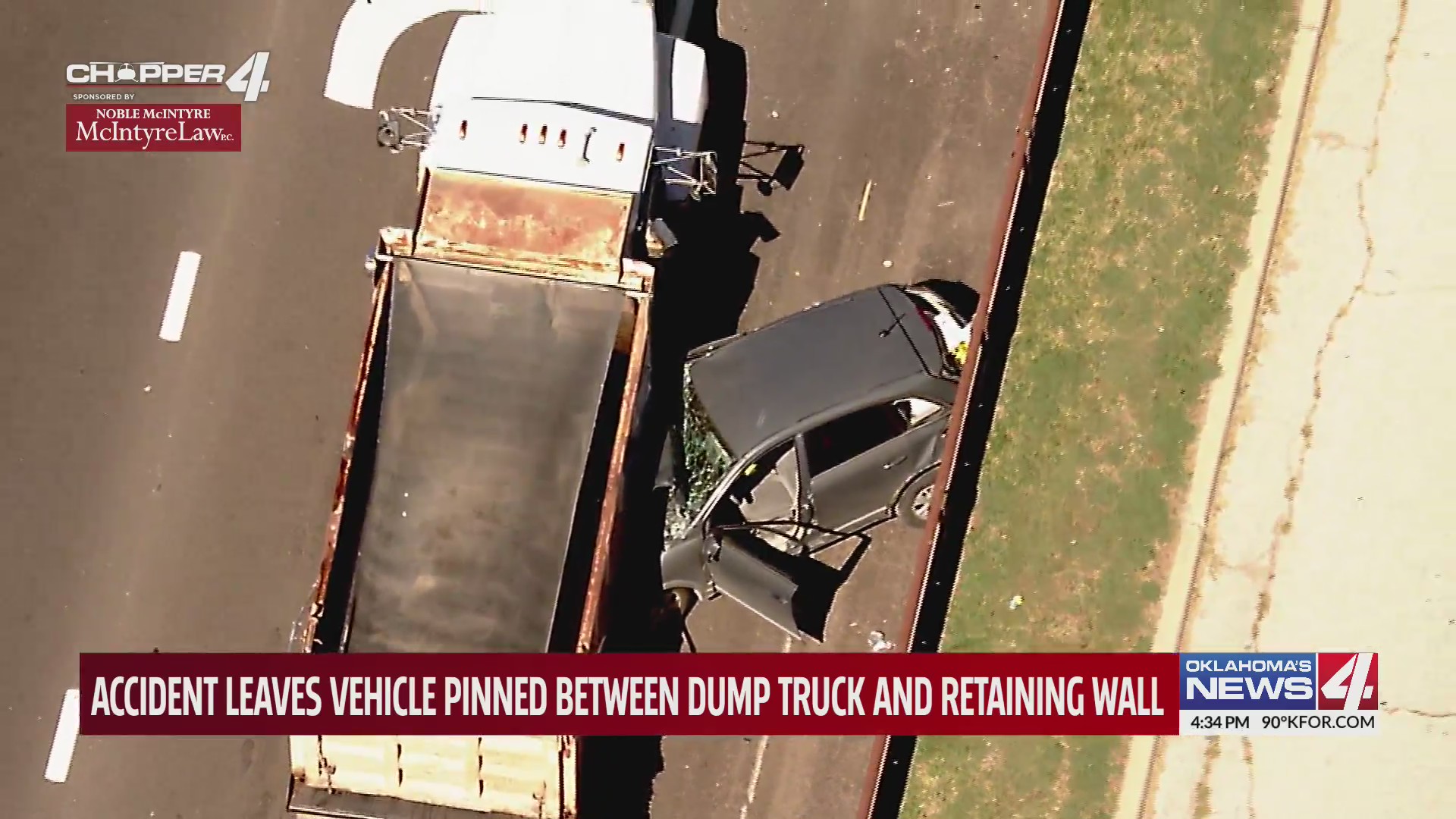 Accident leaves vehicle pinned between dump truck and retaining wall ...