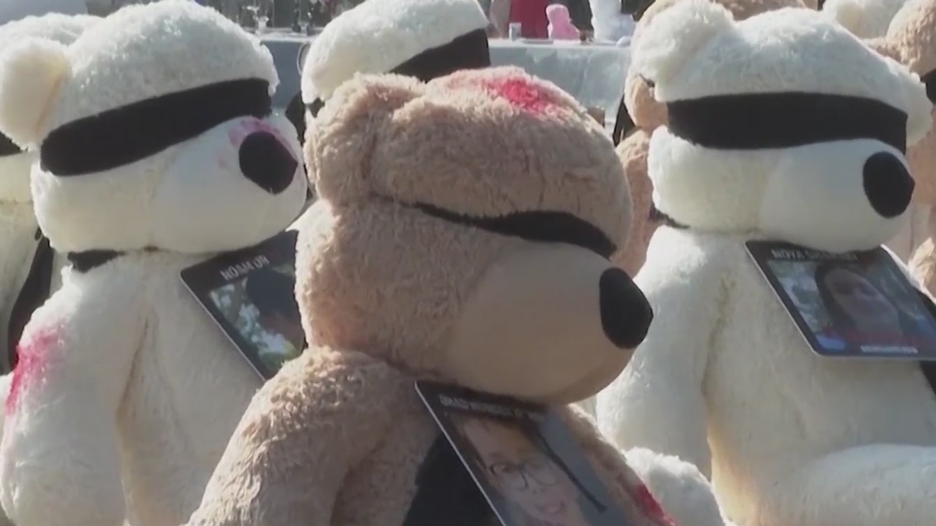 Blindfolded teddy bears with pictures of kidnapped children placed in ...