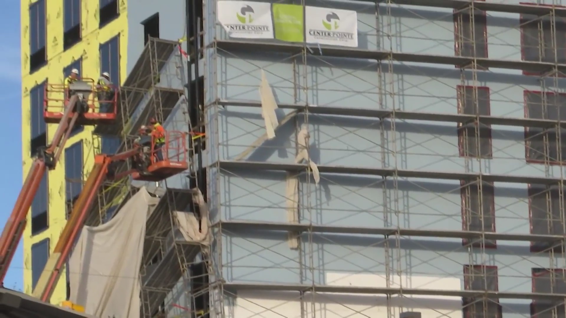 Crews work to take down scaffolding from hotel under construction after ...